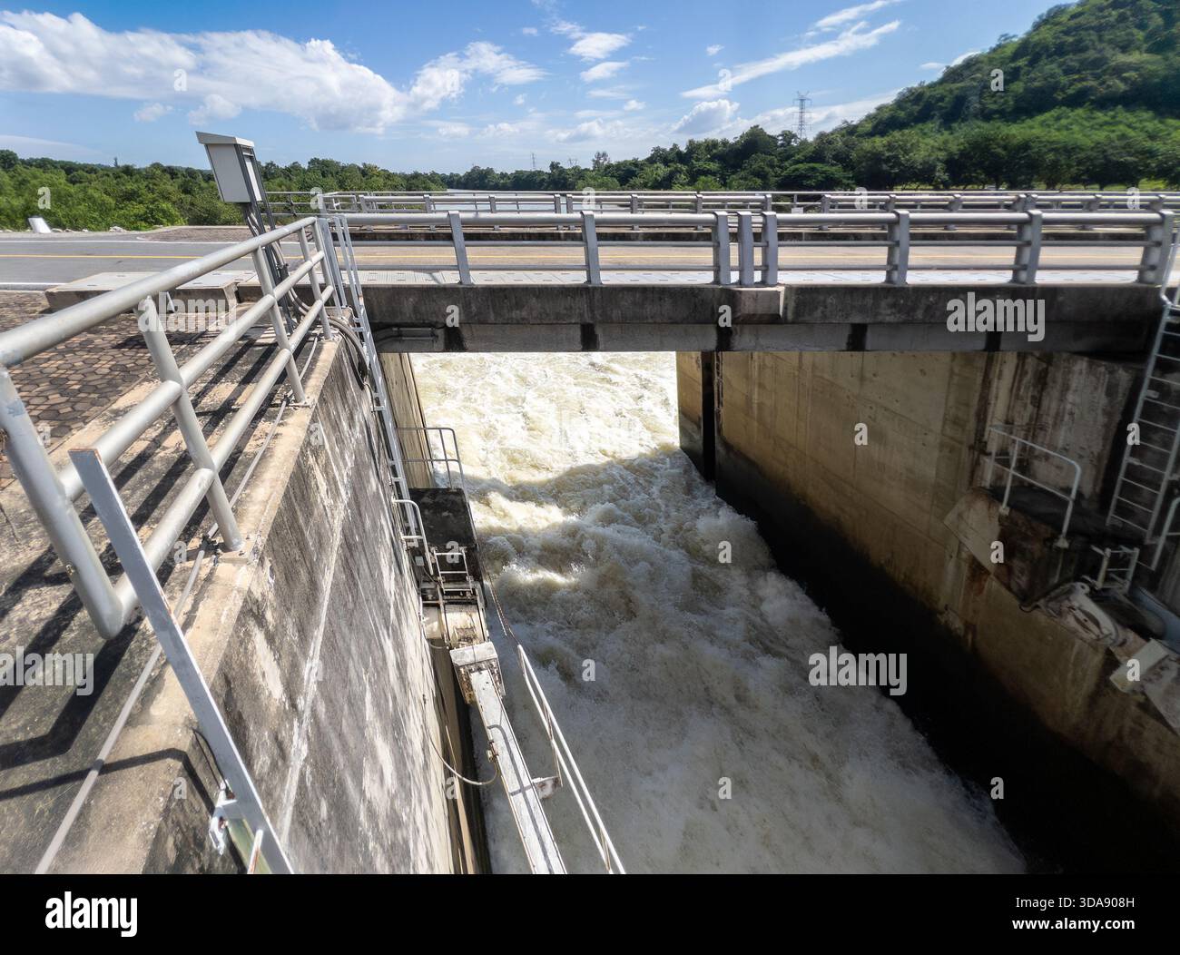 Powerful water discharge from a massive concrete sluice gate under a ...