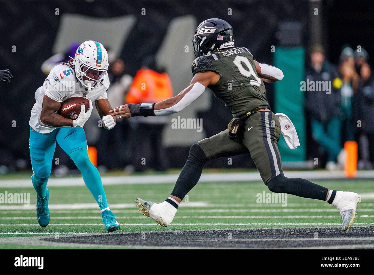 Miami Dolphins running back Jaylen Wright (5) runs into the tackle by ...