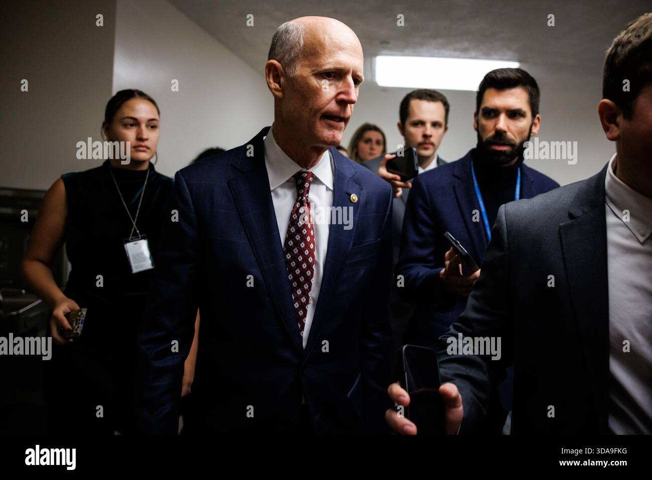 U.S. Sen. Rick Scott (R-FL) speaks to reporters as he walks through the ...