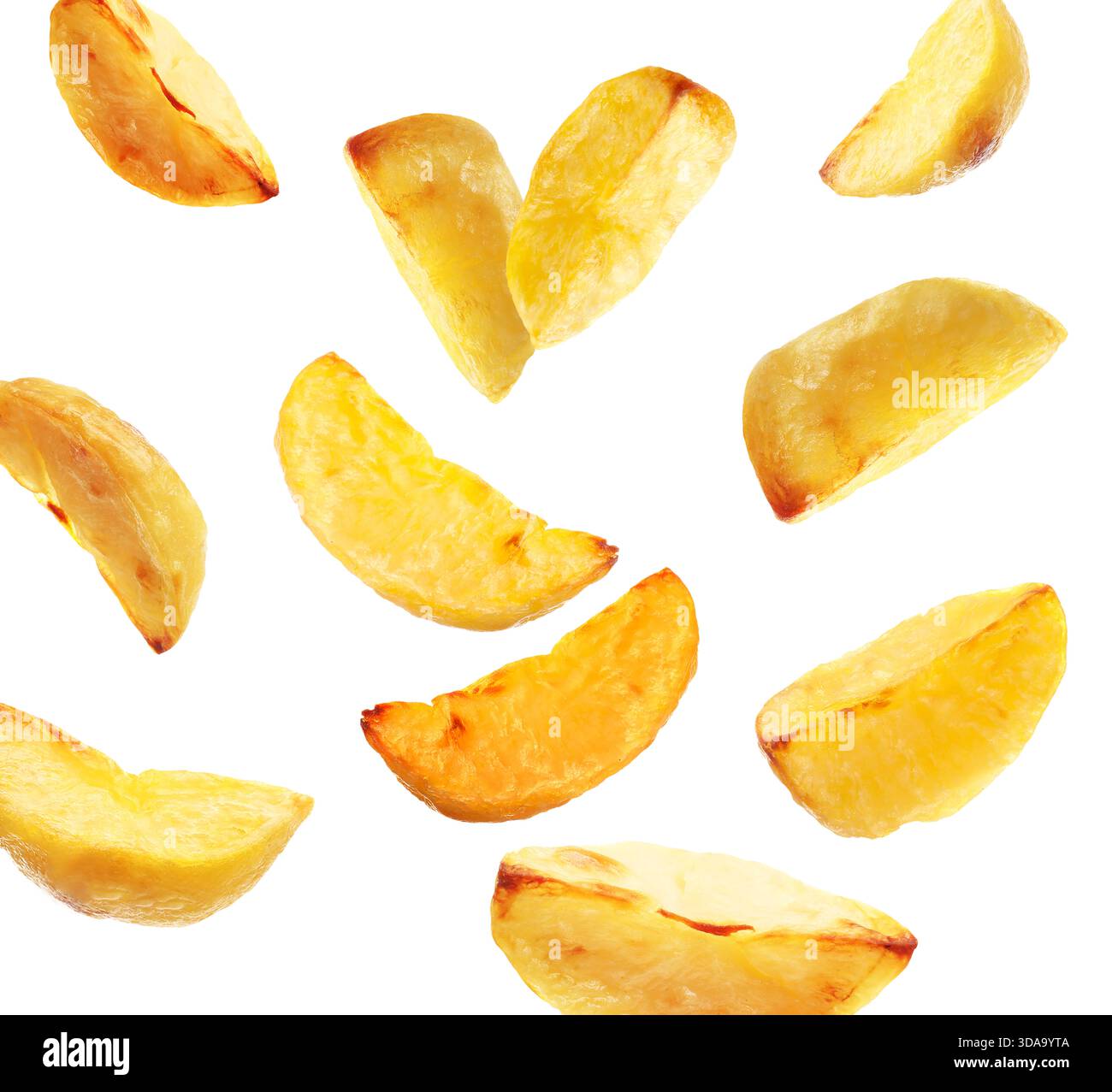 Baked potato wedges falling on white background Stock Photo - Alamy