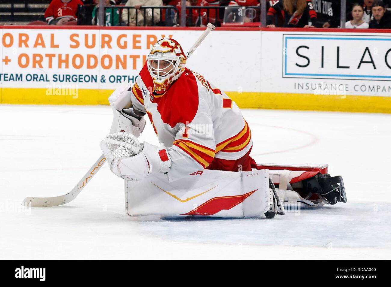 Calgary Flames goaltender Devin Cooley (1) watches the puck against the ...