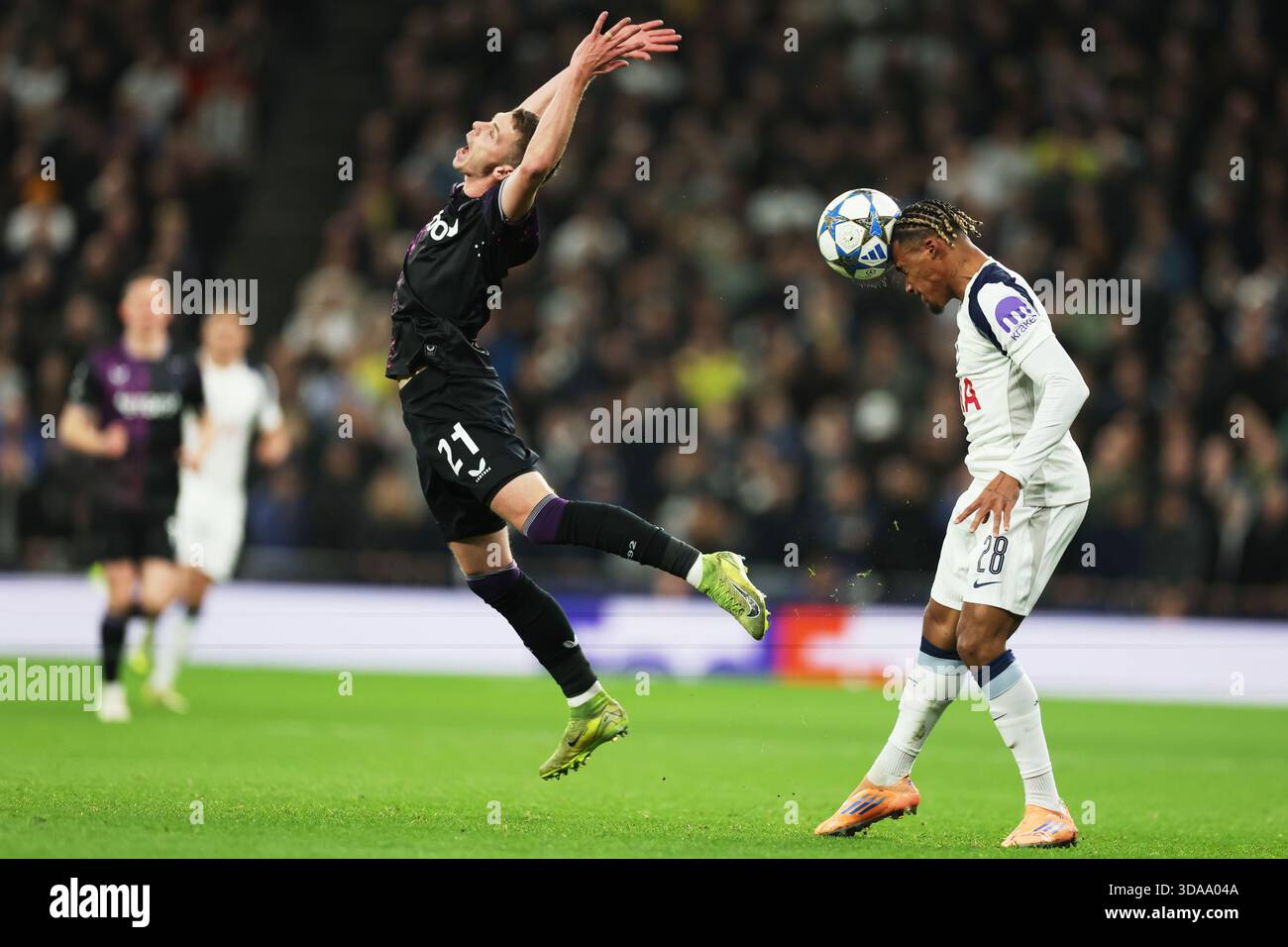 Slavia's David Doudera, left, grimaces as Tottenham's Wilson Odobert ...