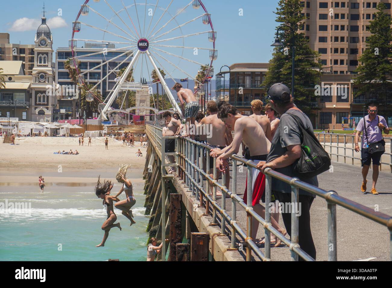 Adelaide, Australia 9 December 2025 Swimmers jump off the jetty pier in ...