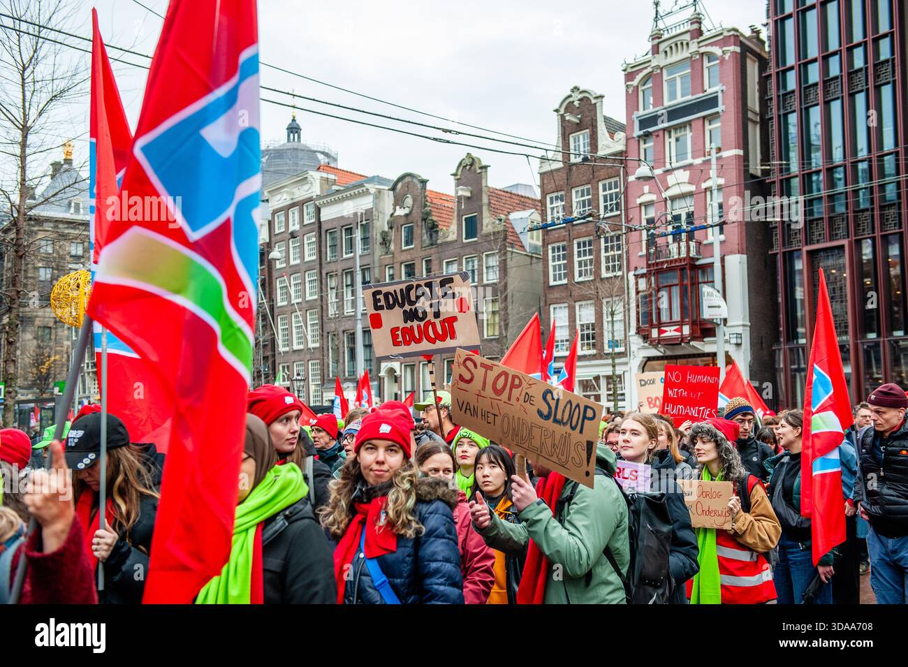 Protesters march with flags and placards against the cuts in education ...