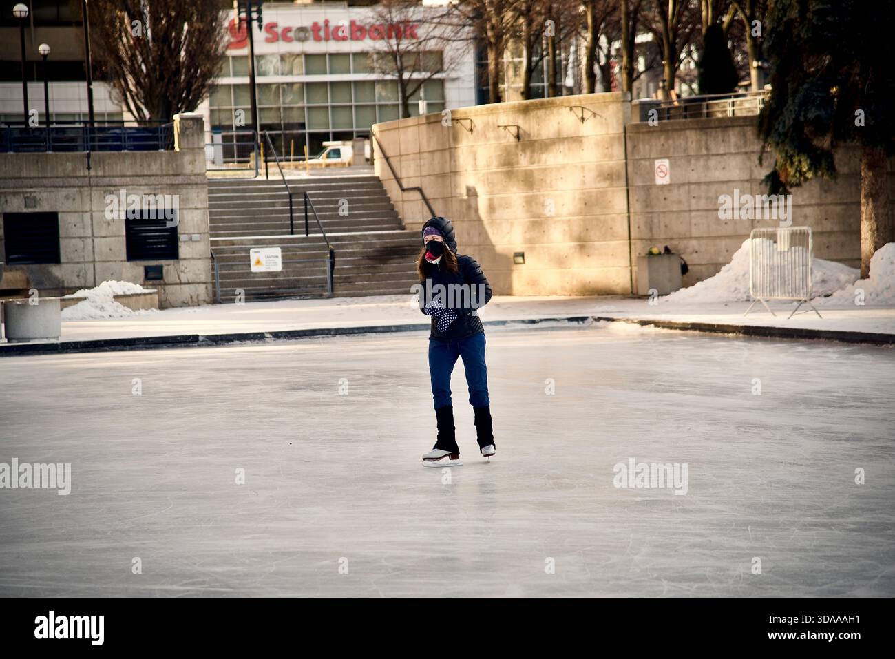 People wearing masks while ice skating at Mel Lastman Square Stock ...
