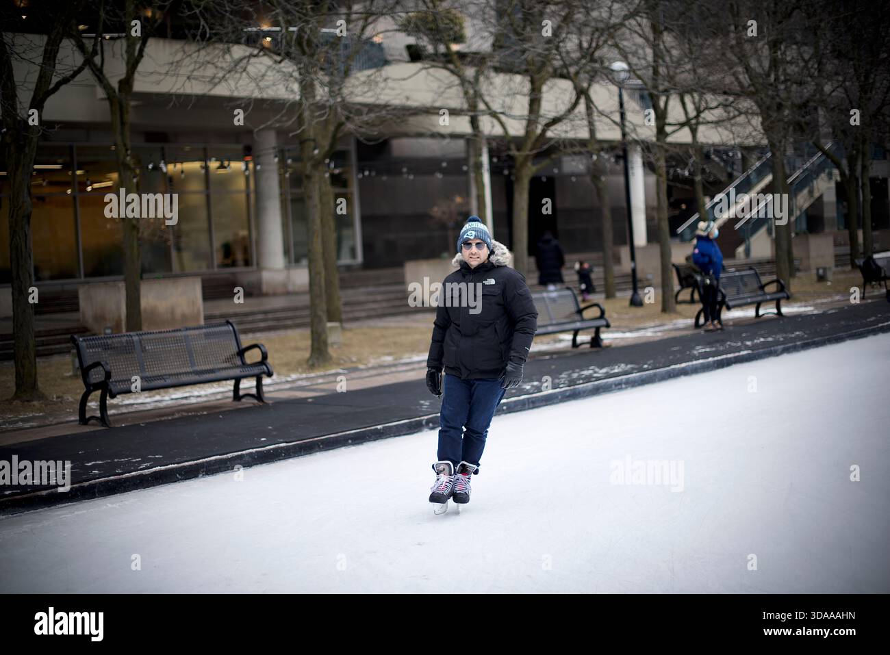 People wearing masks while ice skating at Mel Lastman Square Stock ...