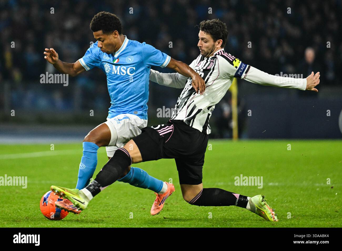 12/7/2025 David Neres of SSC Napoli competes for the ball with Manuel ...