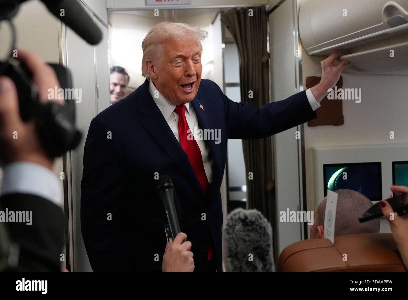 President Donald Trump speaks with reporters while in flight on Air ...