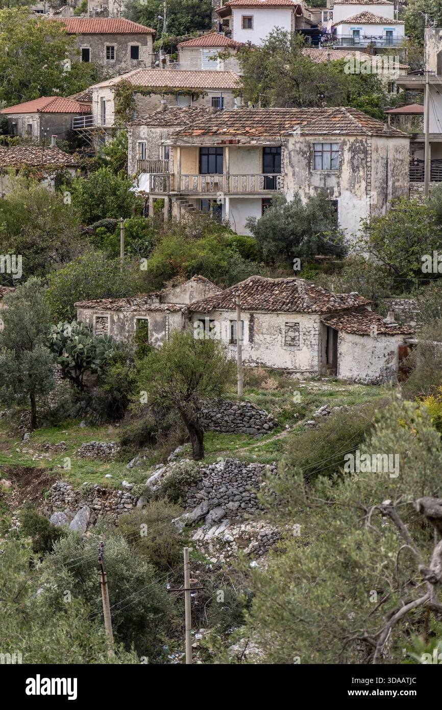 Medieval-looking stone houses and church tower in the historic mountain ...