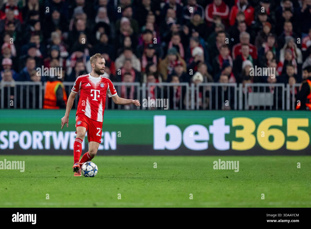 Conrad Laimer (FC FC Bayern Munich, #27) in front of an advertising ...