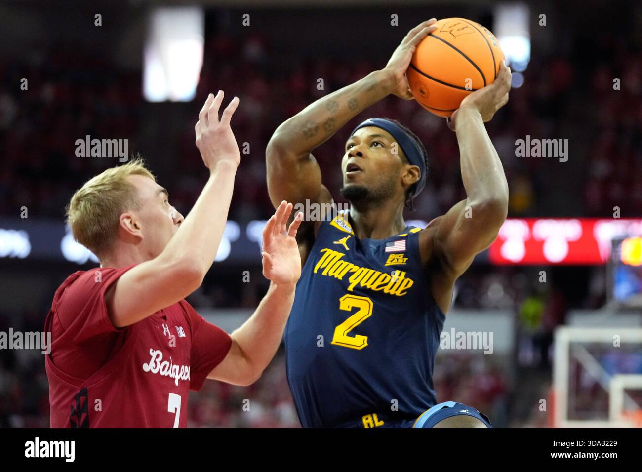 Marquette guard Chase Ross (2) shoots the ball against Wisconsin guard ...