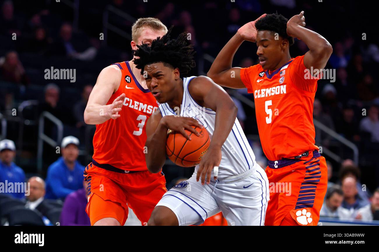 BYU guard Robert Wright III (1) drives to the basket between Clemson ...