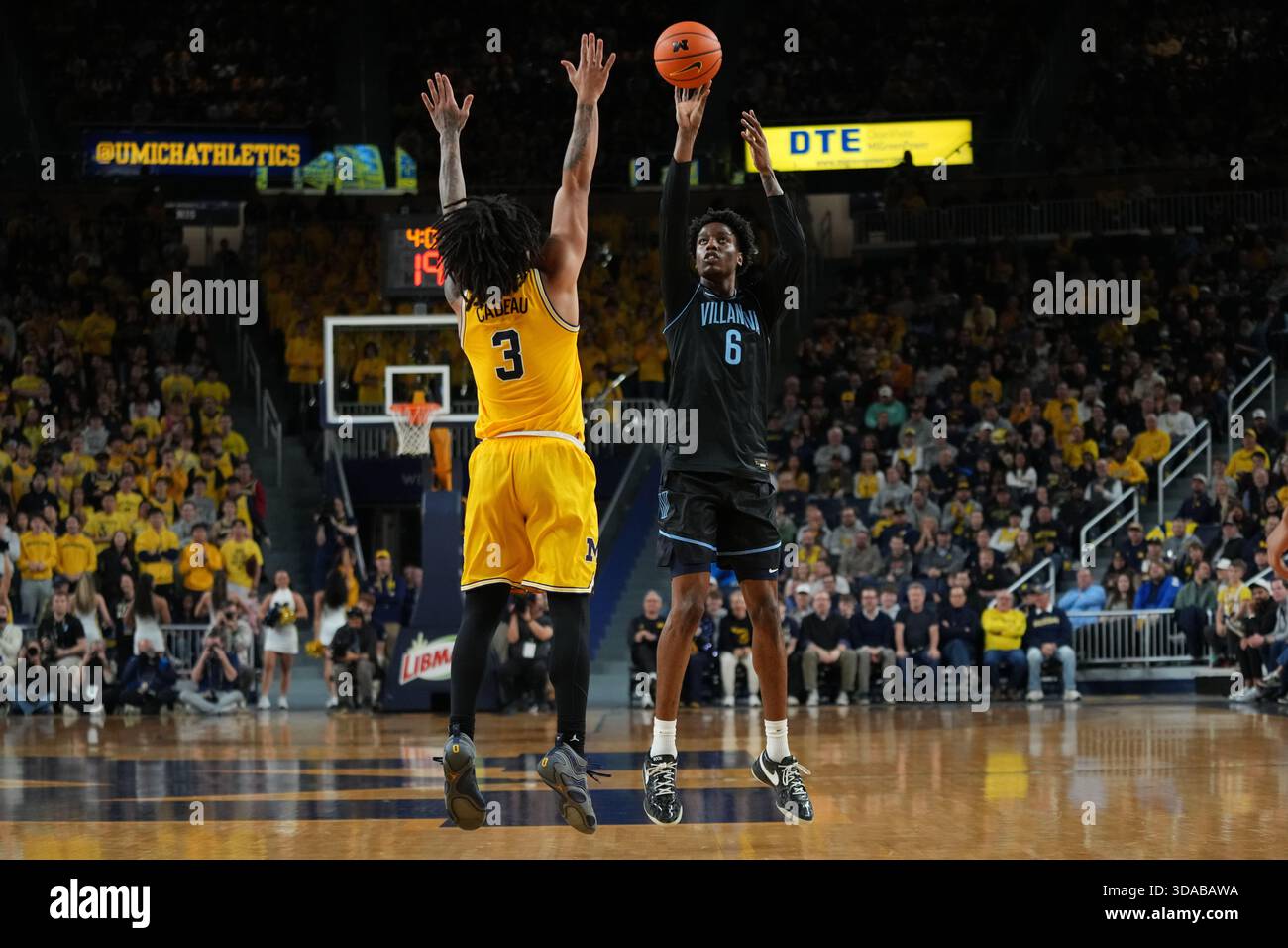 Villanova forward Tafara Gapare, right, shoots against Michigan guard ...