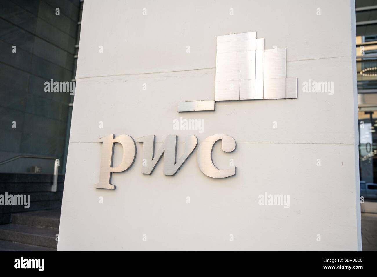 PwC corporate logo mounted on exterior column of downtown office tower ...