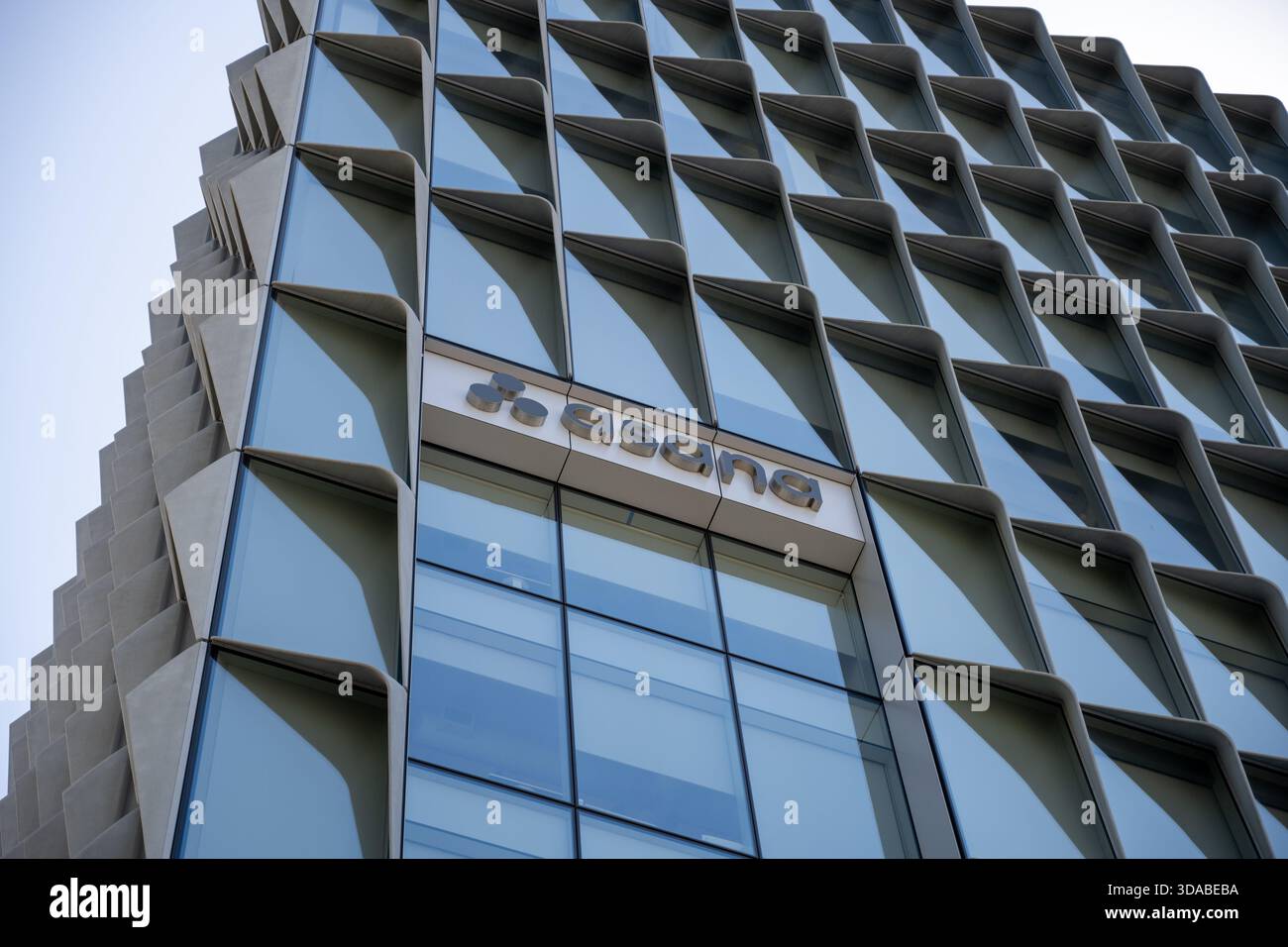 Low-angle view of Asana office tower with geometric glass and concrete ...