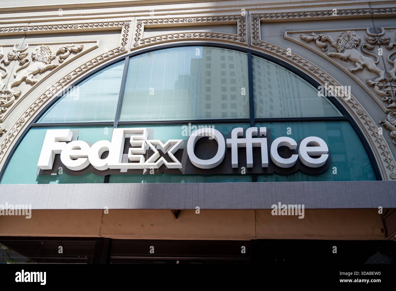 FedEx Office storefront sign beneath arched window on ornate facade ...