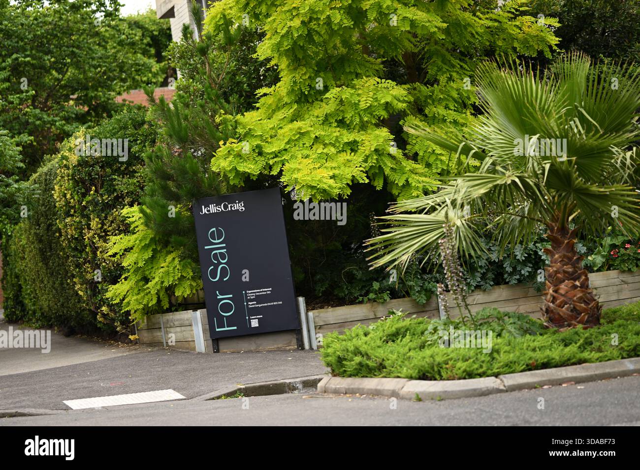 A for sale sign is seen along the street frontage of an apartment block ...