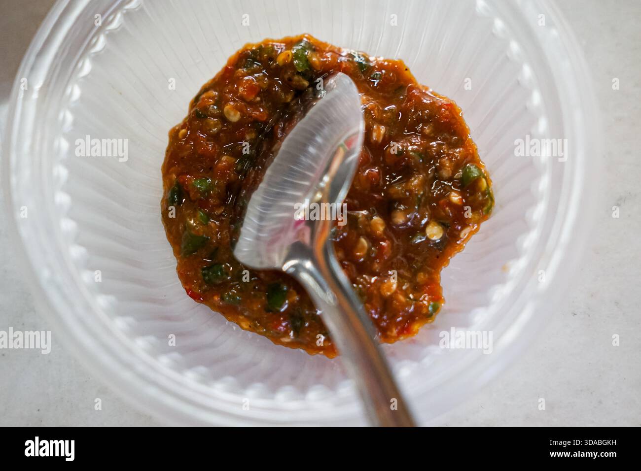 Homemade sambal belacan with red and green chilies, served in a clear ...