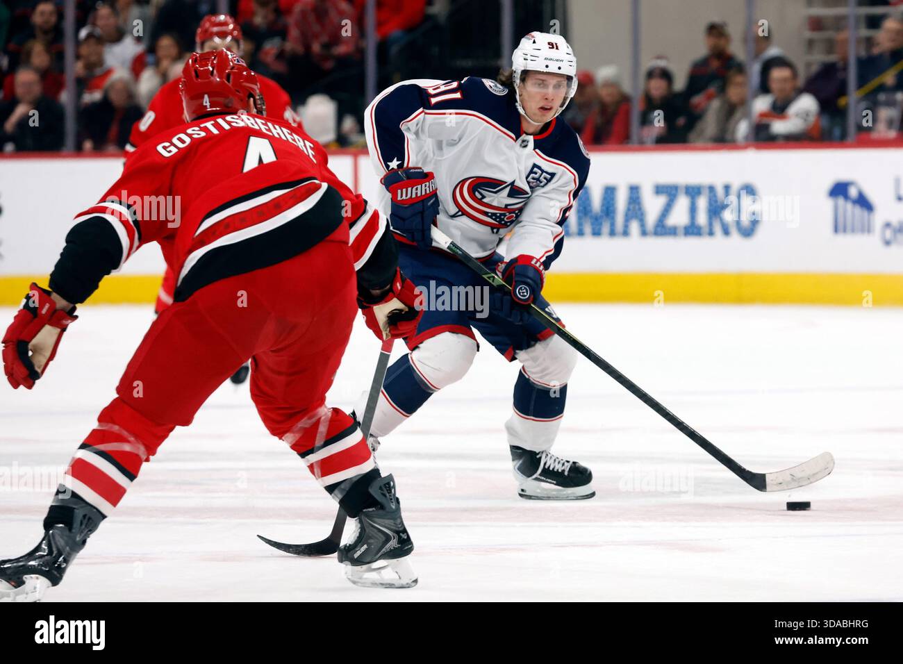 Columbus Blue Jackets' Kent Johnson (91) controls the puck as he ...