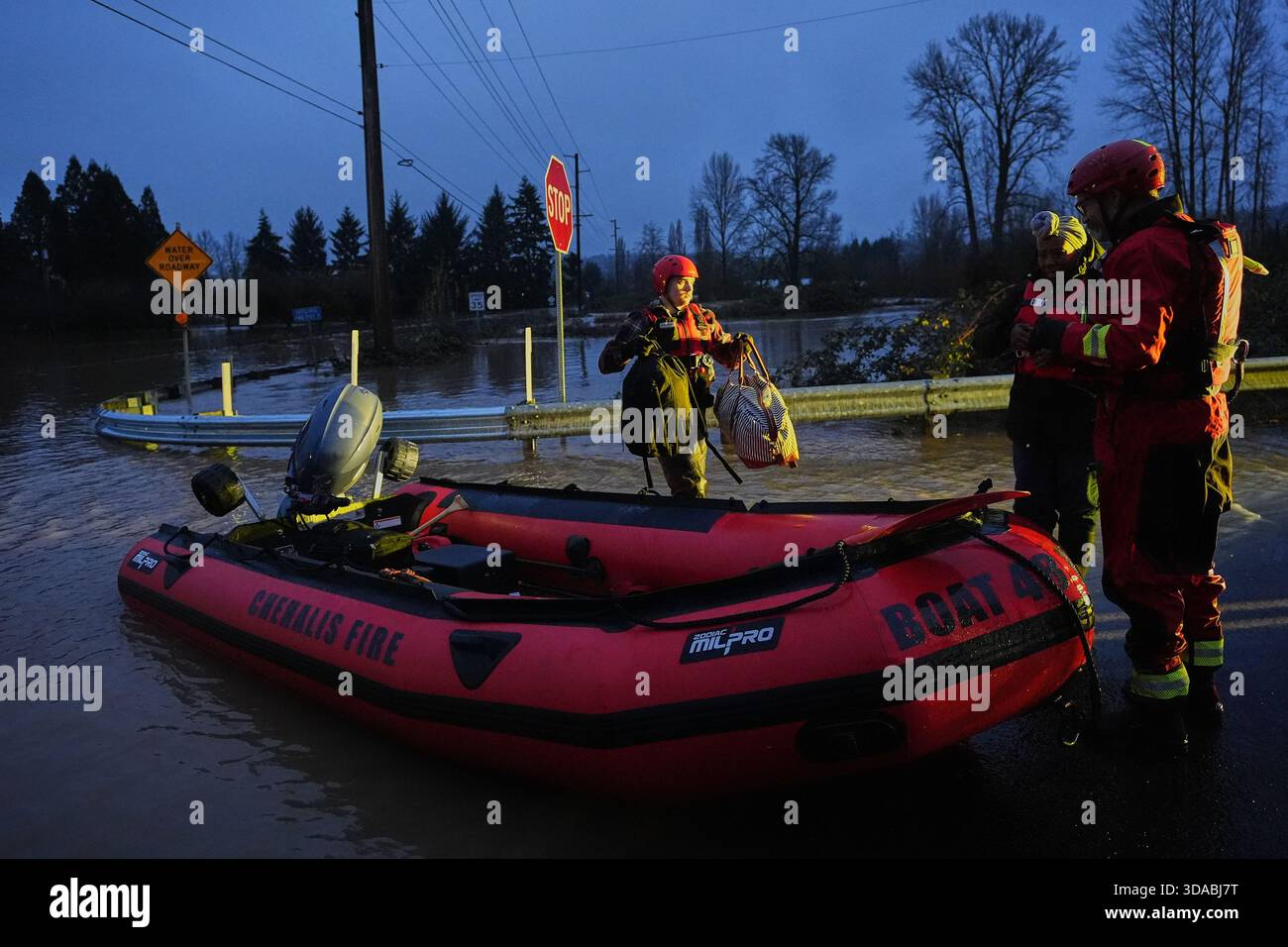 Chehalis Fire rescue workers help residents evacuate their flooded ...