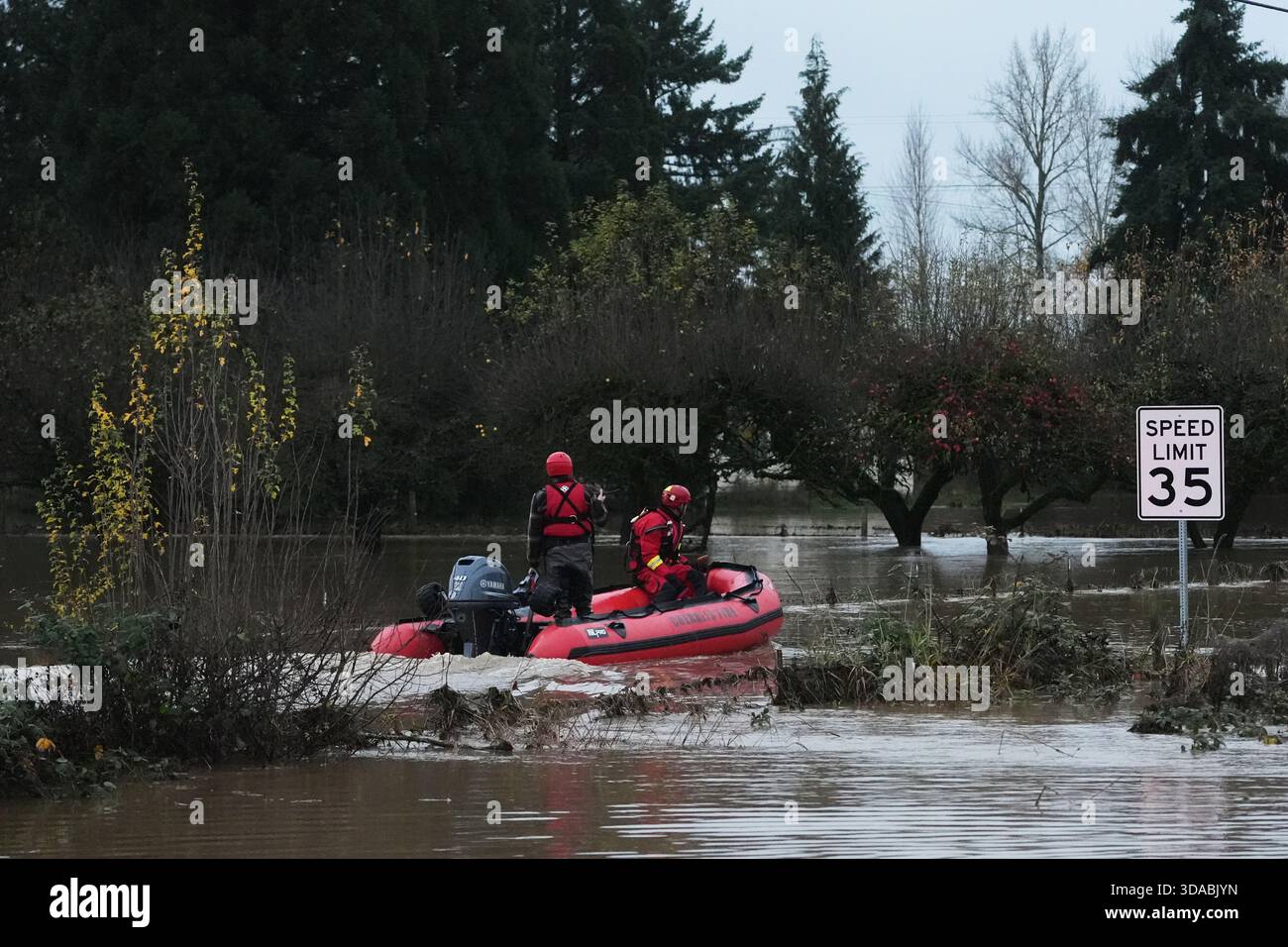 Rescue workers with Chehalis Fire venture into a flooded neighborhood ...