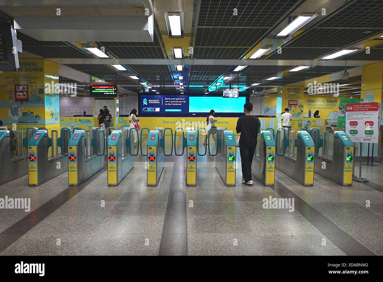 Gantries at concourse level of City Hall MRT Station, a major ...