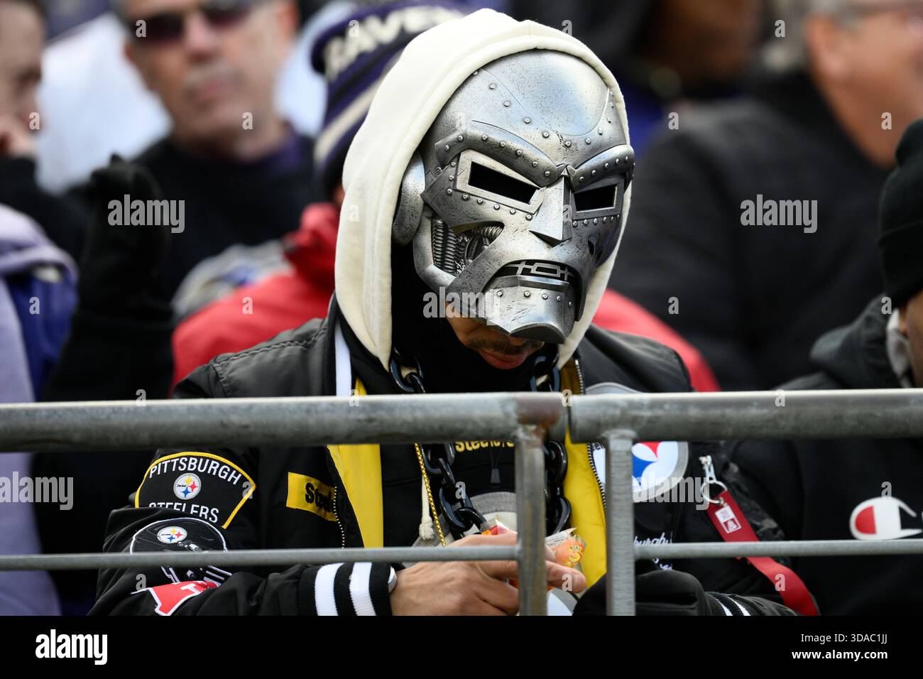 A spectator watches during the first half of an NFL football game ...