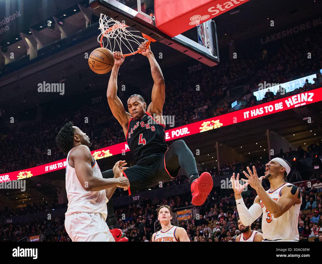 Toronto Raptors' Scottie Barnes (4) dunks as New York Knicks' Josh Hart ...