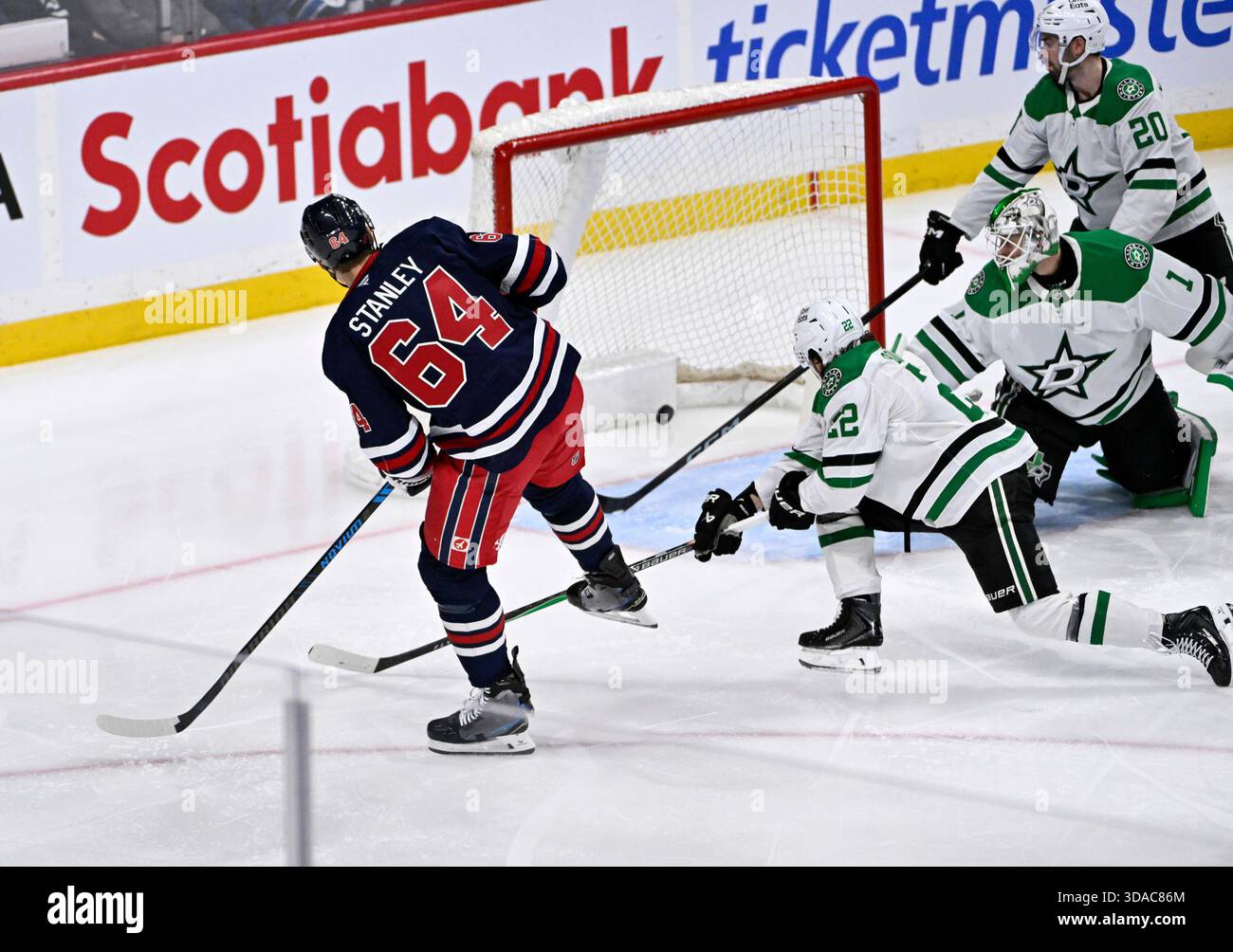 Winnipeg Jets' Logan Stanley (64) scores on Dallas Stars' goaltender ...