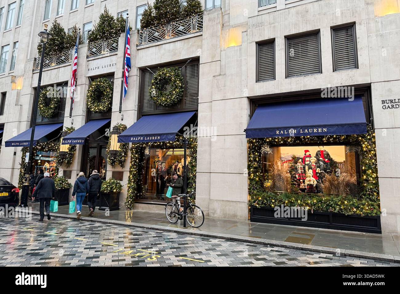 Holiday shoppers walk in front of the Ralph Lauren store in central ...