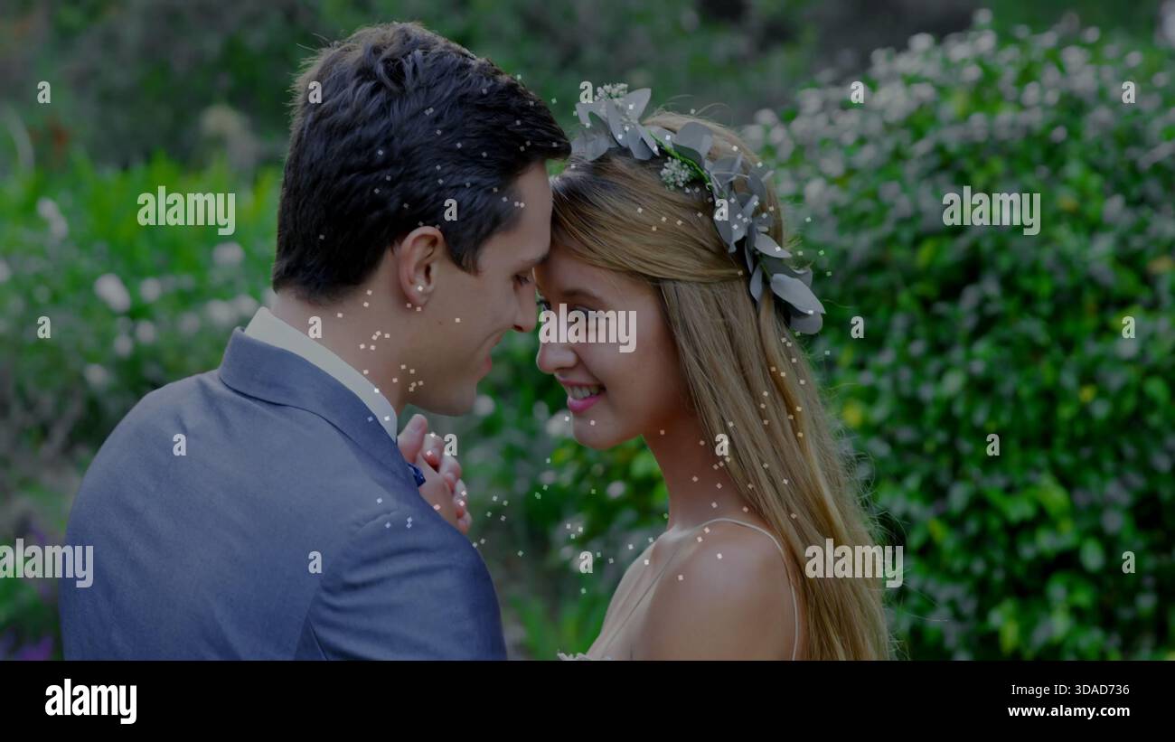 Romantic couple is standing forehead to forehead with confetti outdoor ...