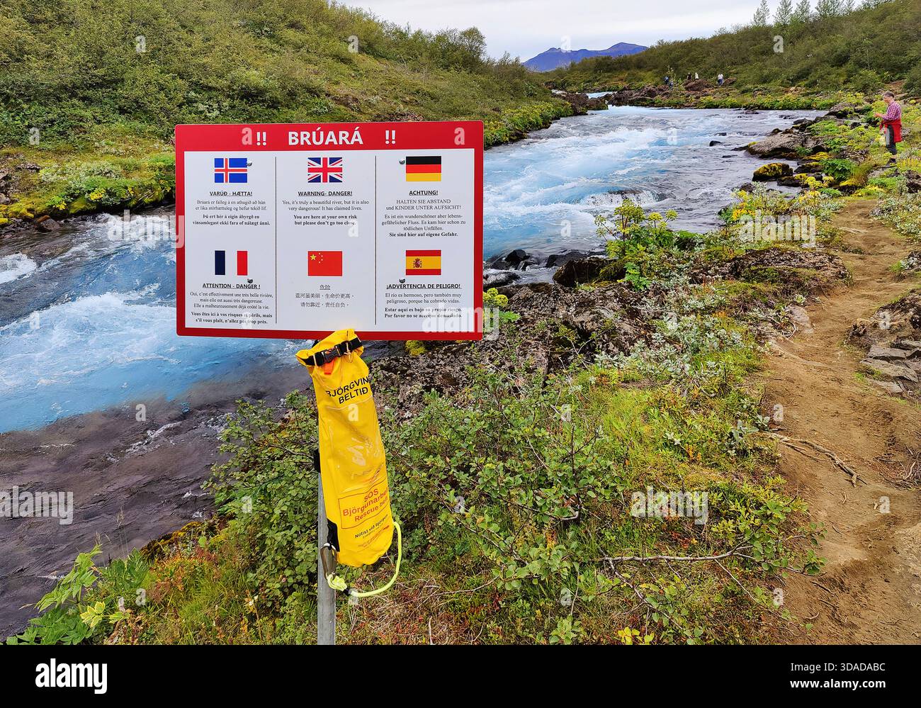 Warning sign in six languages and lifebelt in front of the dangerous ...