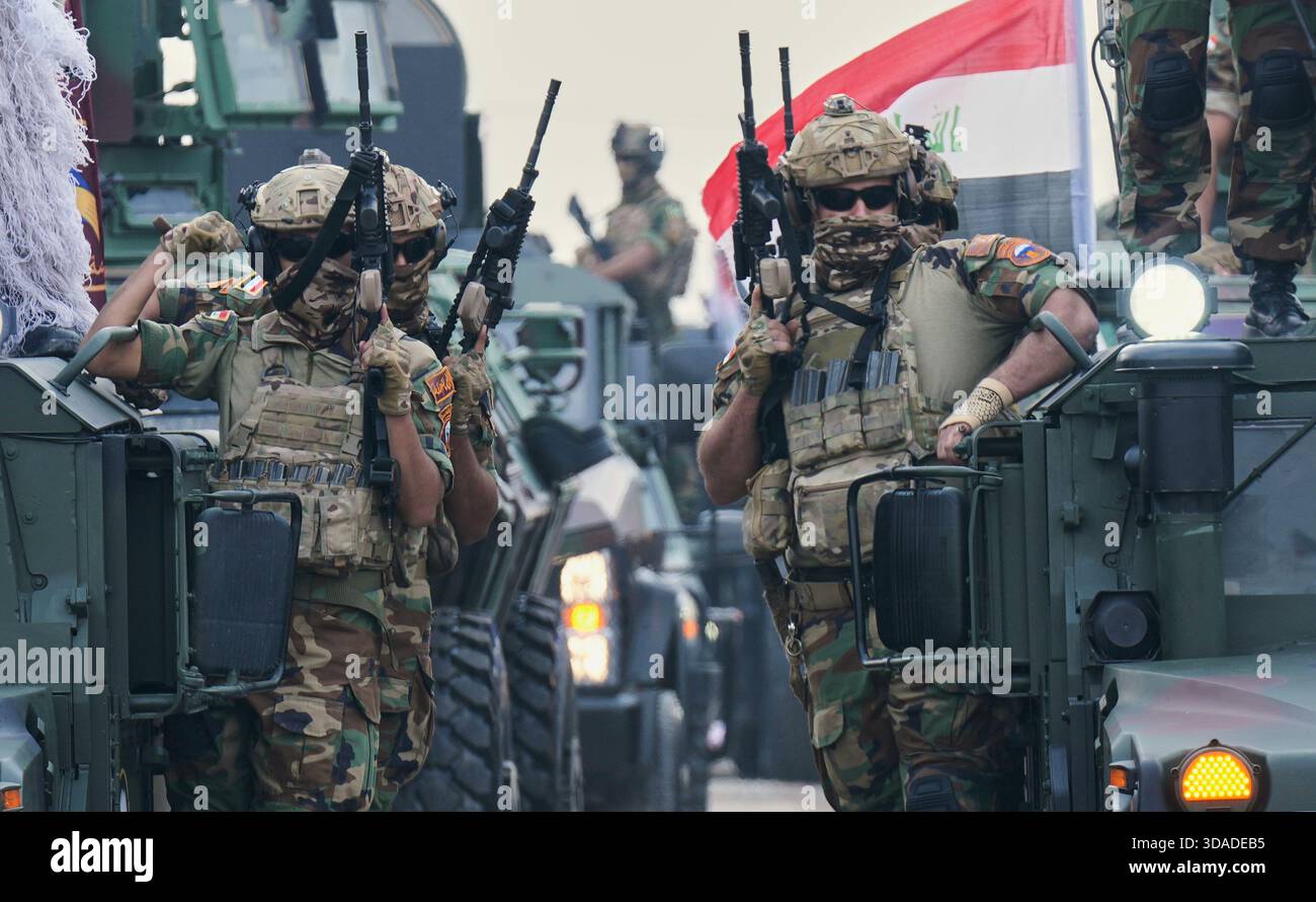 Iraqi army soldiers take part in a parade during a ceremony marking the ...