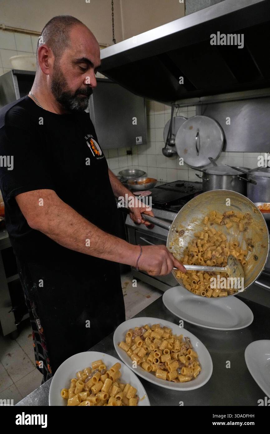Italian cook Massimo Dante prepares a Carbonara at his restaurant in ...