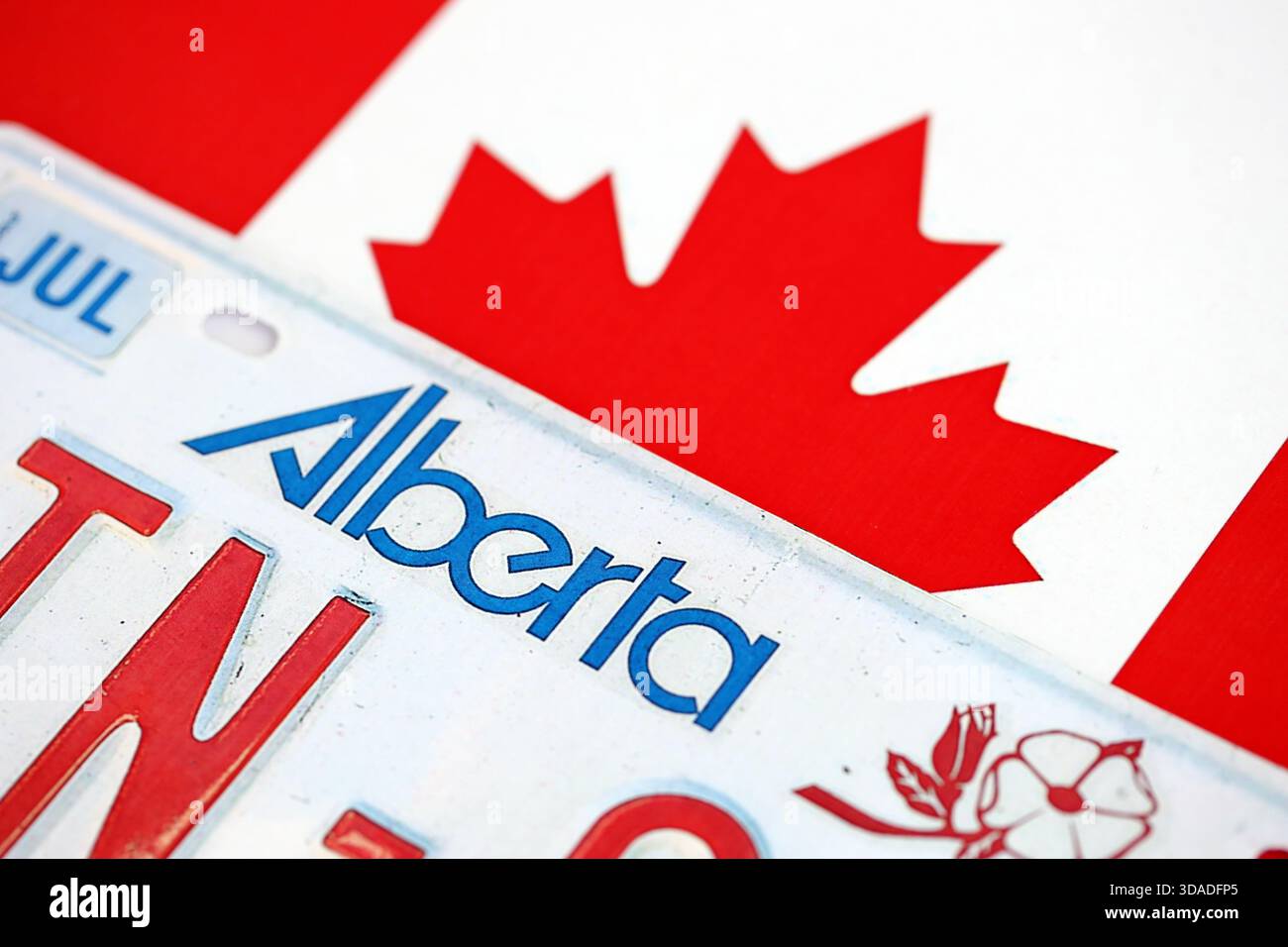 Alberta canadian car license plate on flag of Canada close up. Driving ...