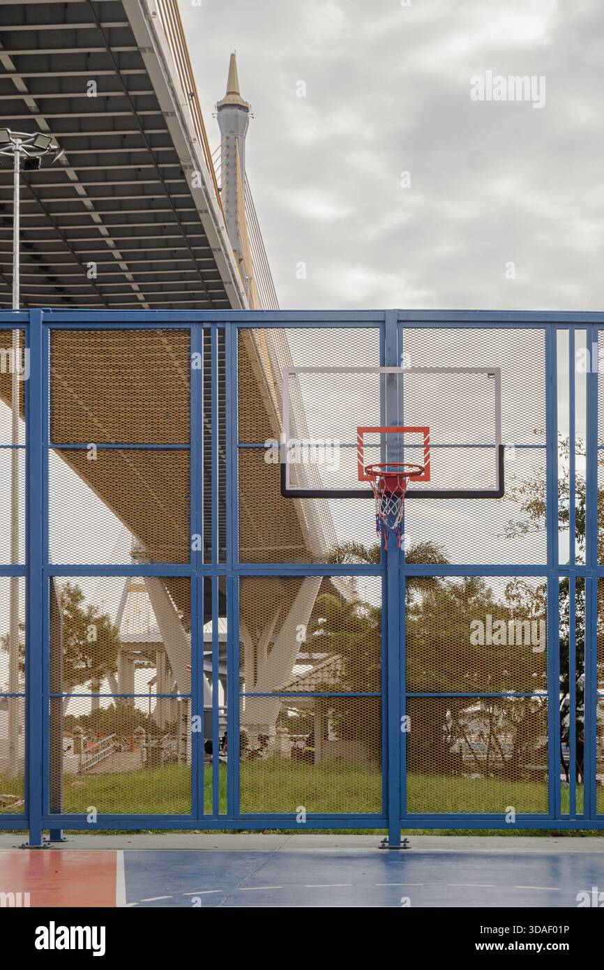 An outdoor basketball court, featuring an orange and blue playing ...
