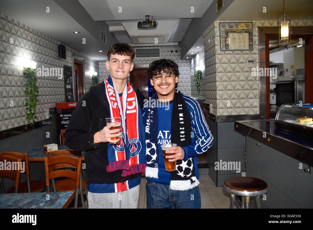 Bilbao, Spain, December 10, 2025: PSG fans drink beer and are seen in ...