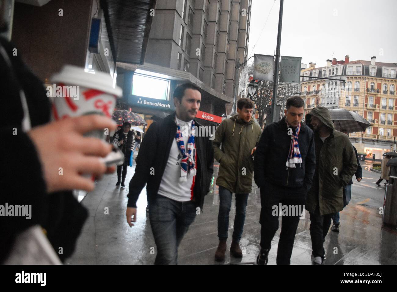 Bilbao, Spain, December 10, 2025: PSG fans drink beer and are seen in ...
