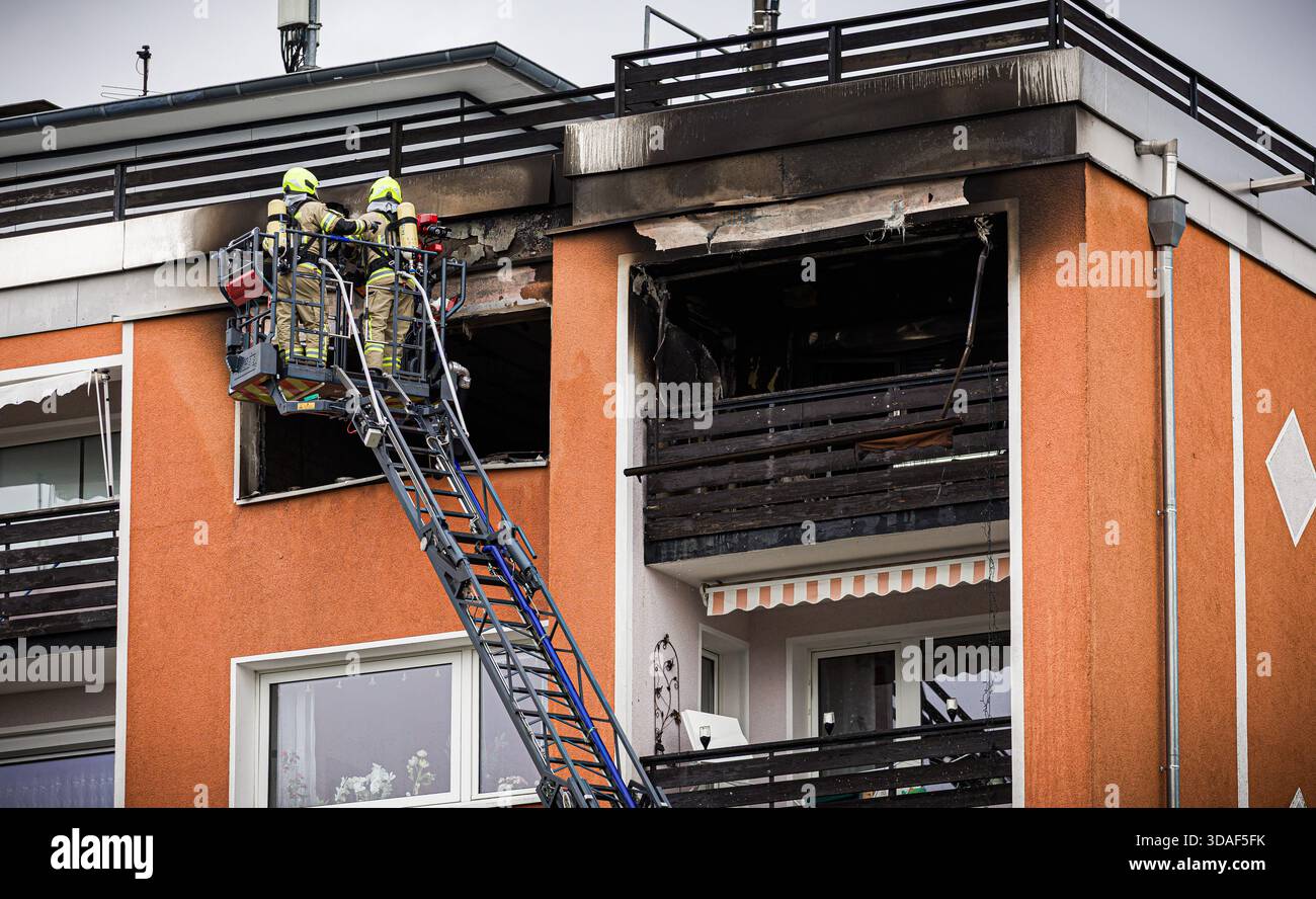 10 December 2025, Lower Saxony, Pattensen: Two firefighters stand in ...