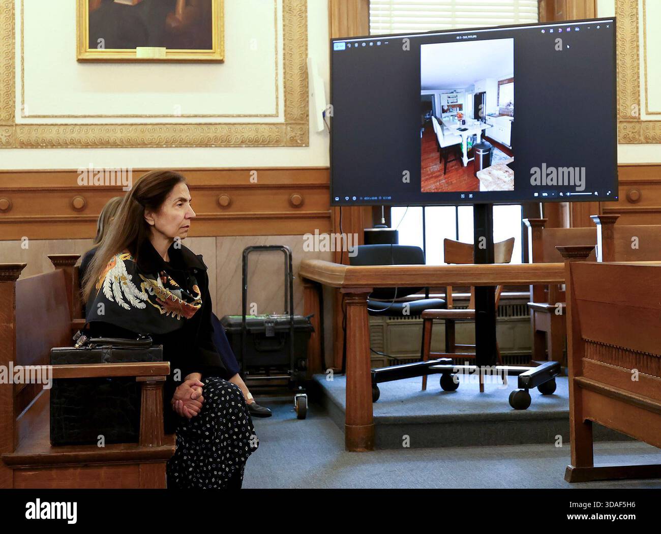 Diana Walshe listens to testimony as a photo of Brian Walshe's kitchen ...