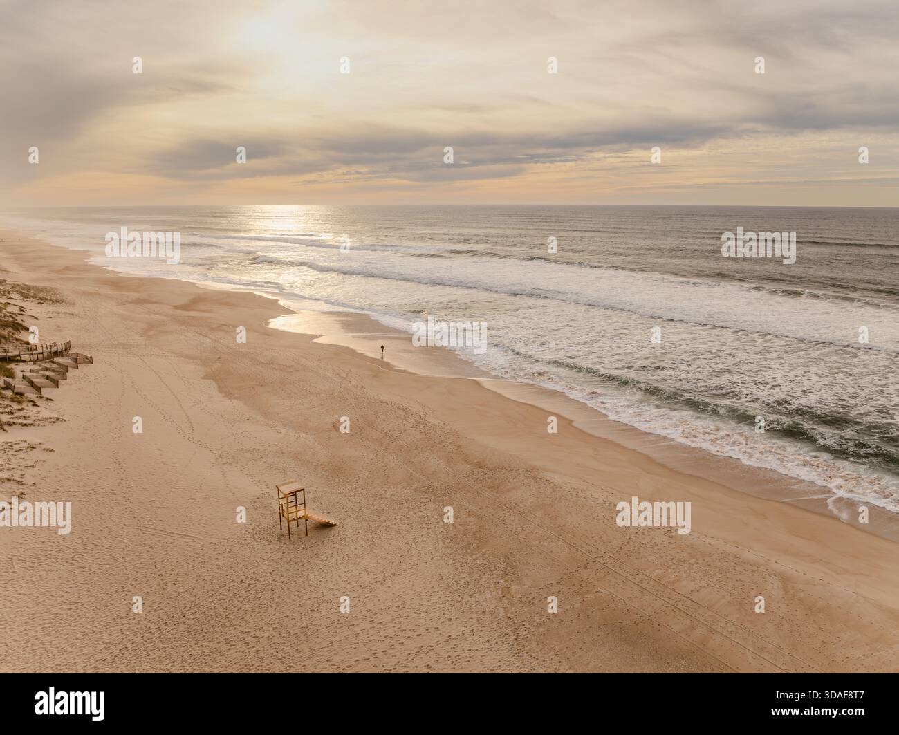 Aerial view of golden sands meeting the rhythmic ocean waves under a ...