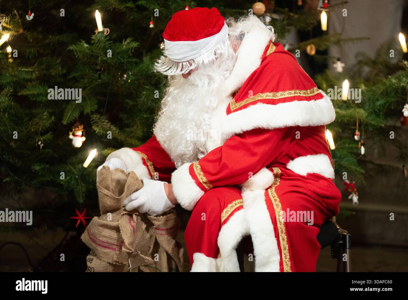 10 December 2025, Saxony, Dresden: A man dressed as Santa Claus takes ...