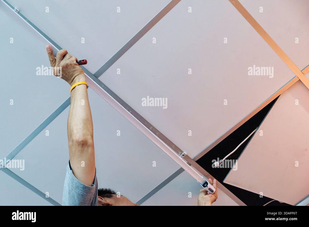 Technician installing ceiling mounted hi-res stock photography and ...