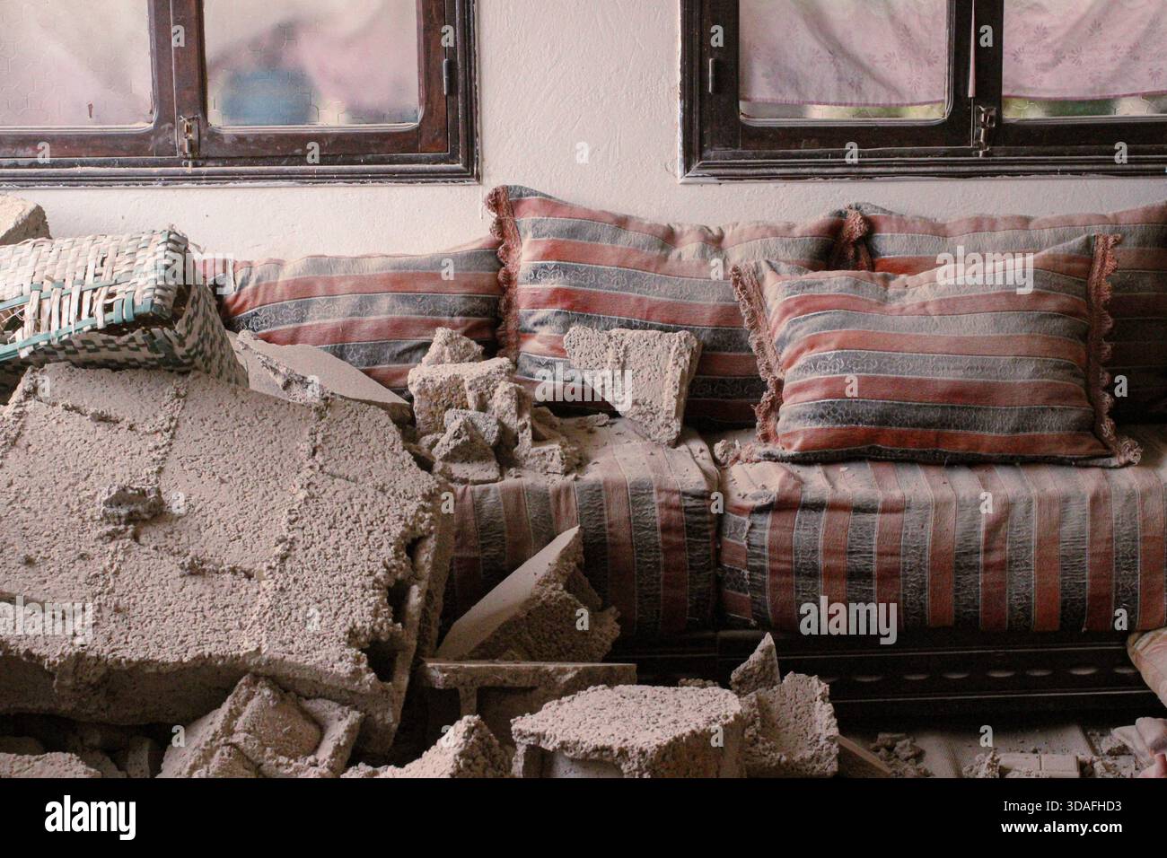 A damaged living room is seen after two residential buildings collapsed ...
