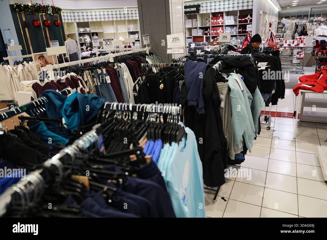 A person browses clothing racks inside a Macy's department store in ...