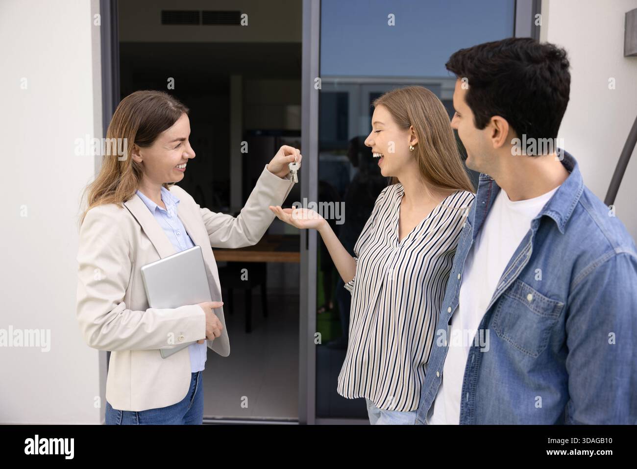 Happy married couple receiving new home keys Stock Photo - Alamy