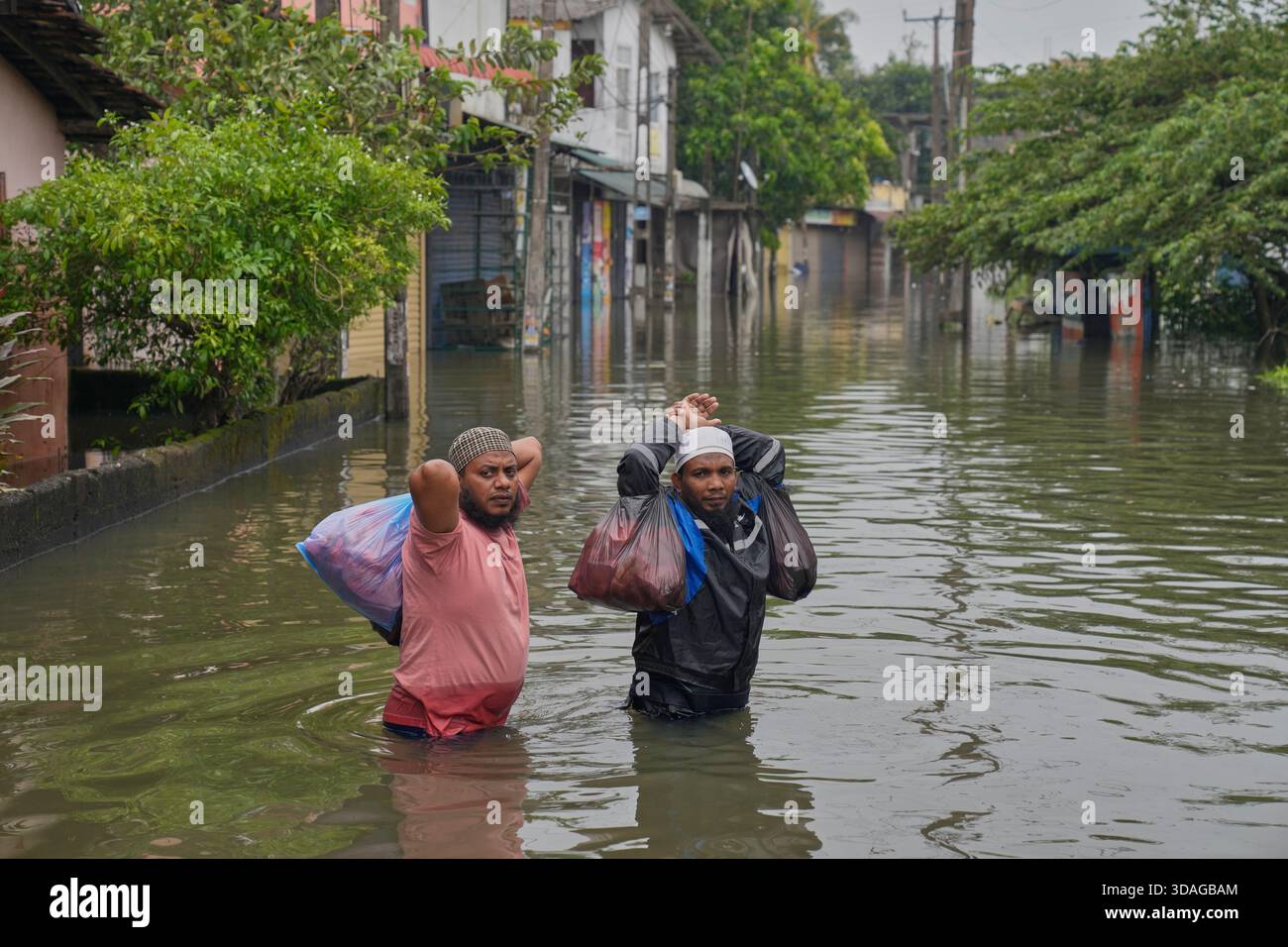 FILE - People wade through floodwaters in the aftermath of Cyclone ...