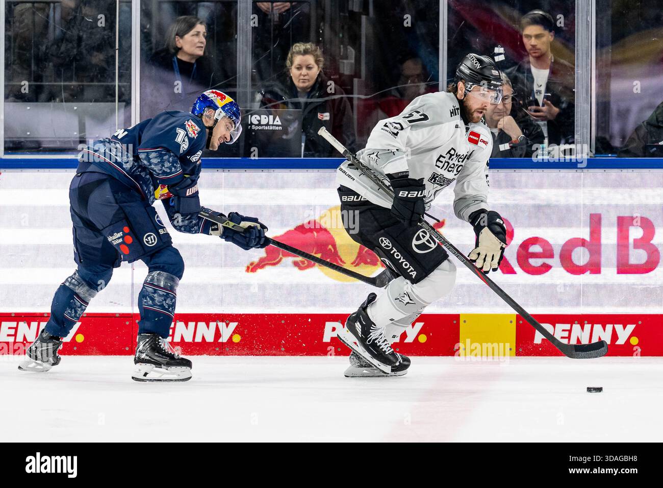 Puck battle / Duel between Brady Ferguson (EHC Red Bull Munich, #12 ...
