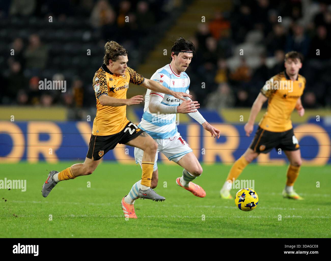 Hull City's Regan Slater (left) and Wrexham's Kieffer Moore battle for ...
