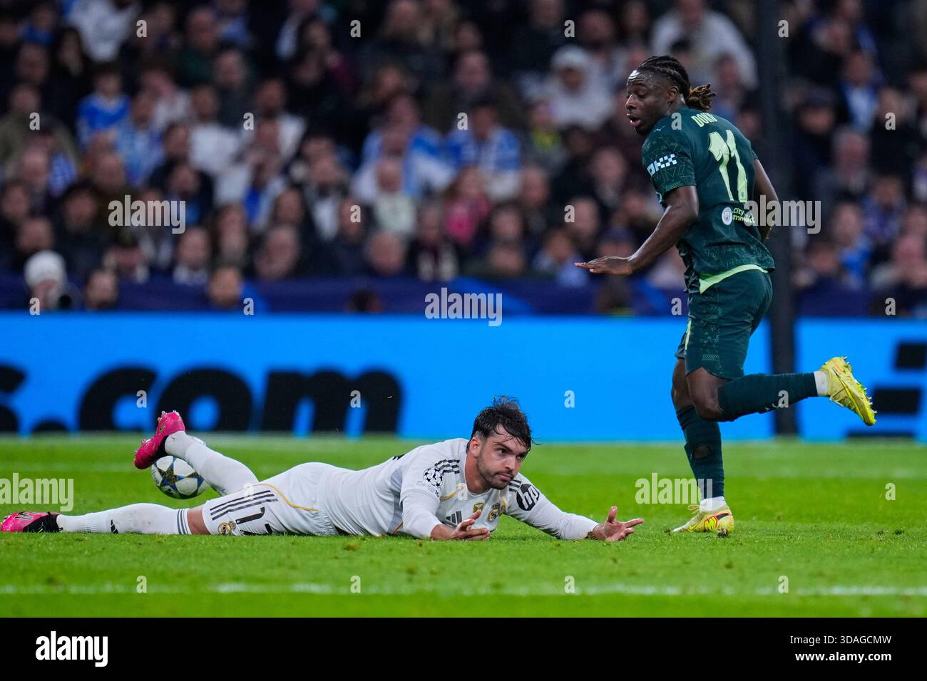 Manchester City's Jeremy Doku, right, gestures next to Real Madrid's ...